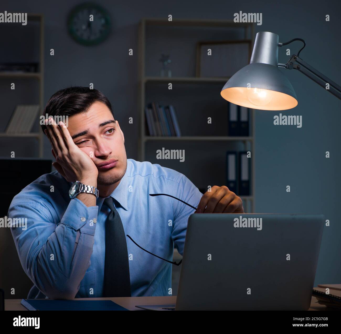 The employee working late at night at important report Stock Photo - Alamy