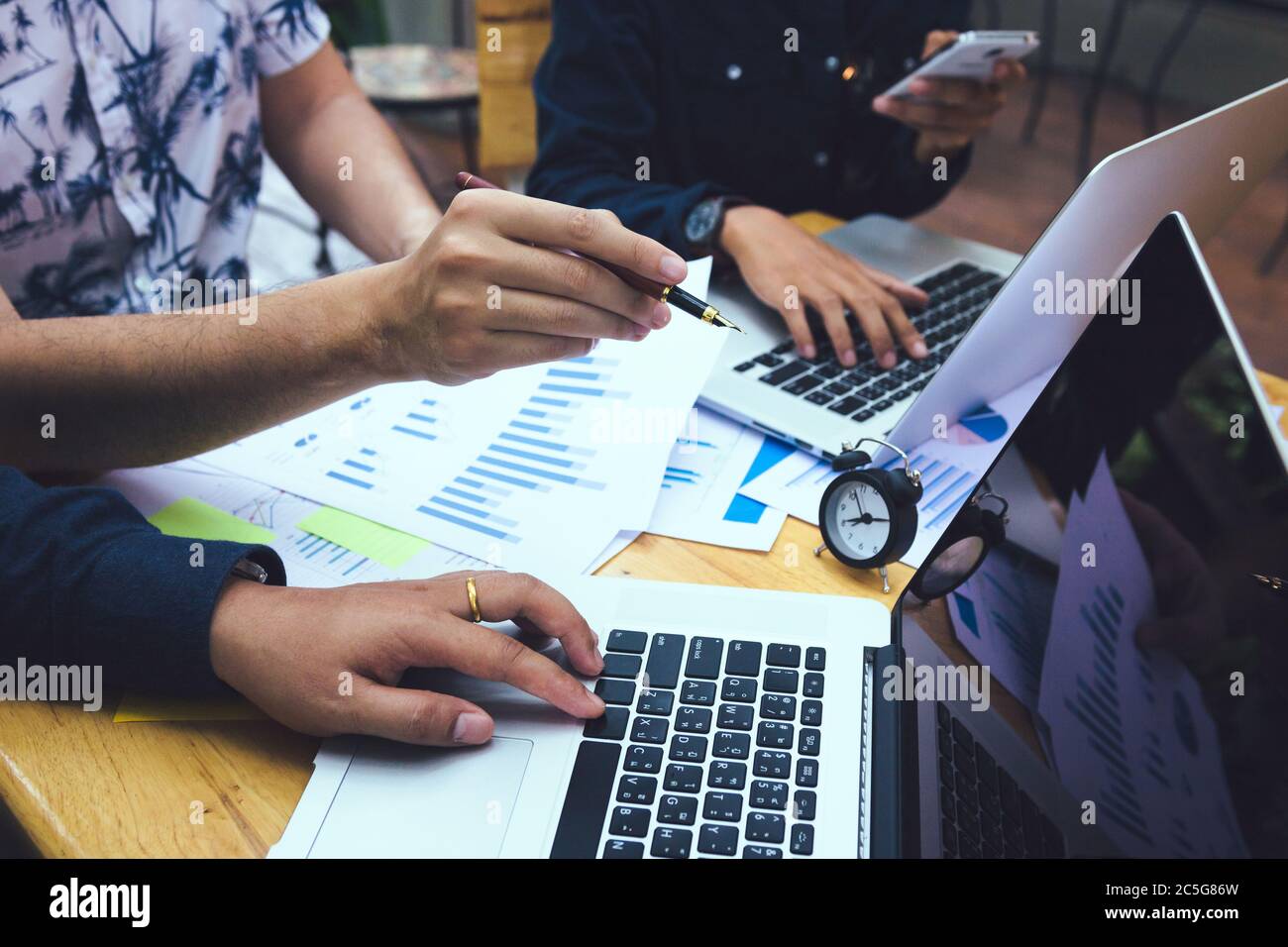 Team business people analysis summary report graph on laptop in office ...