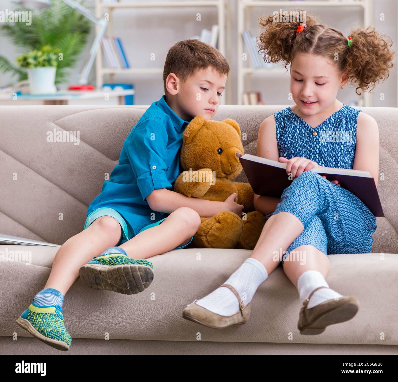 The two kids reading books at home Stock Photo - Alamy