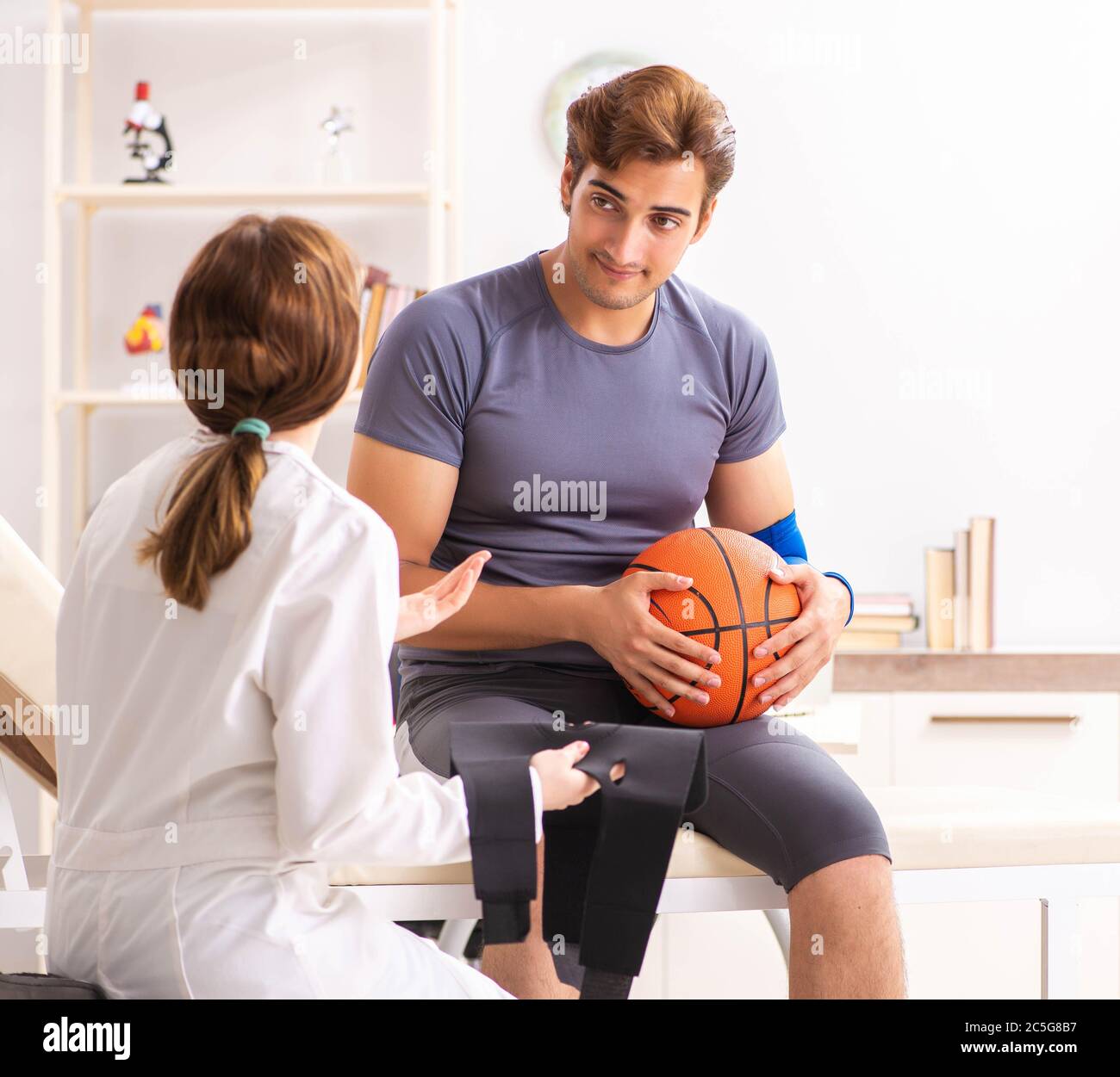The handsome basketball player visiting female doctor traumatologist ...