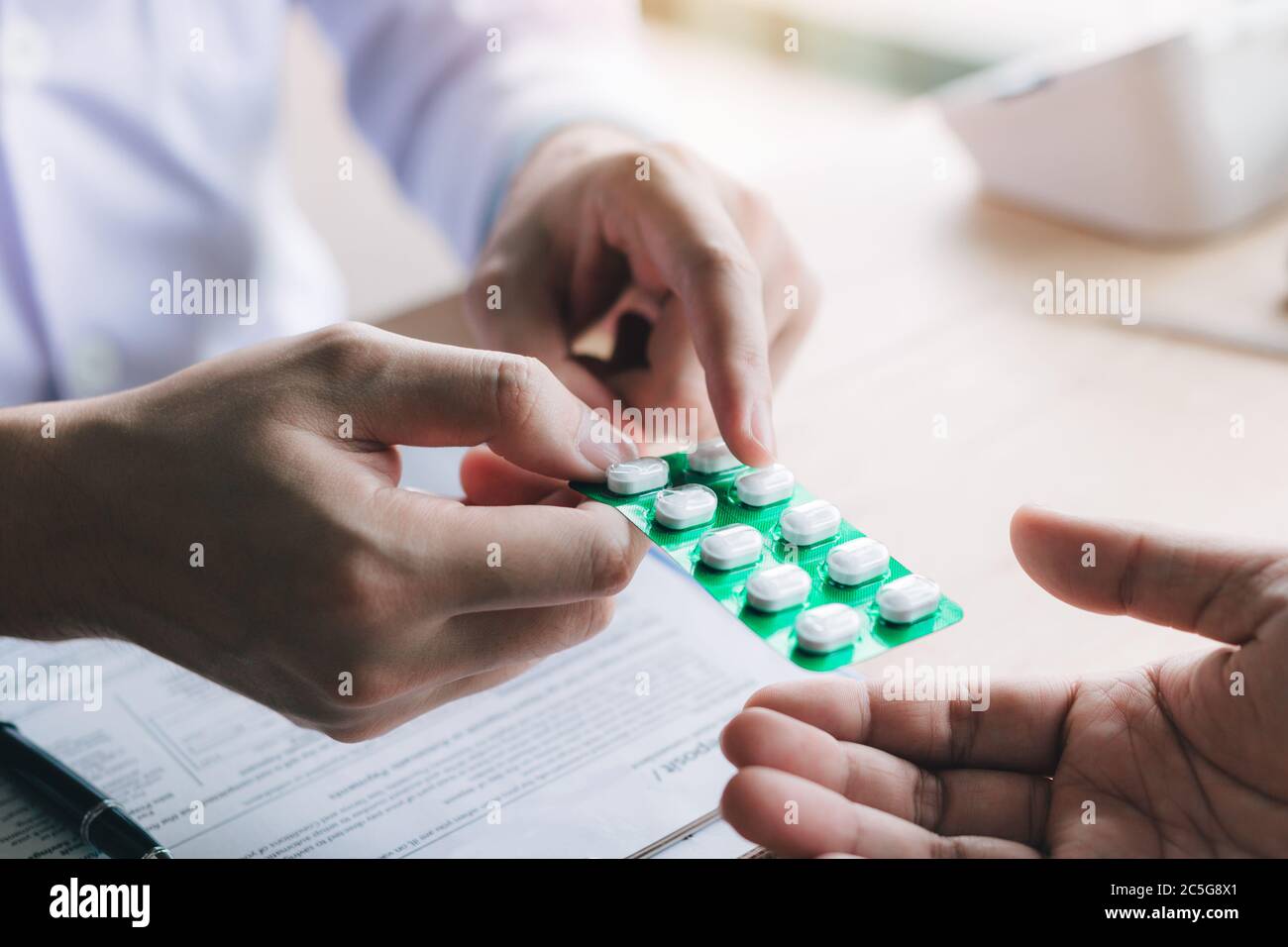 Doctor is pointing to drug tablet and introducing the properties of the ...