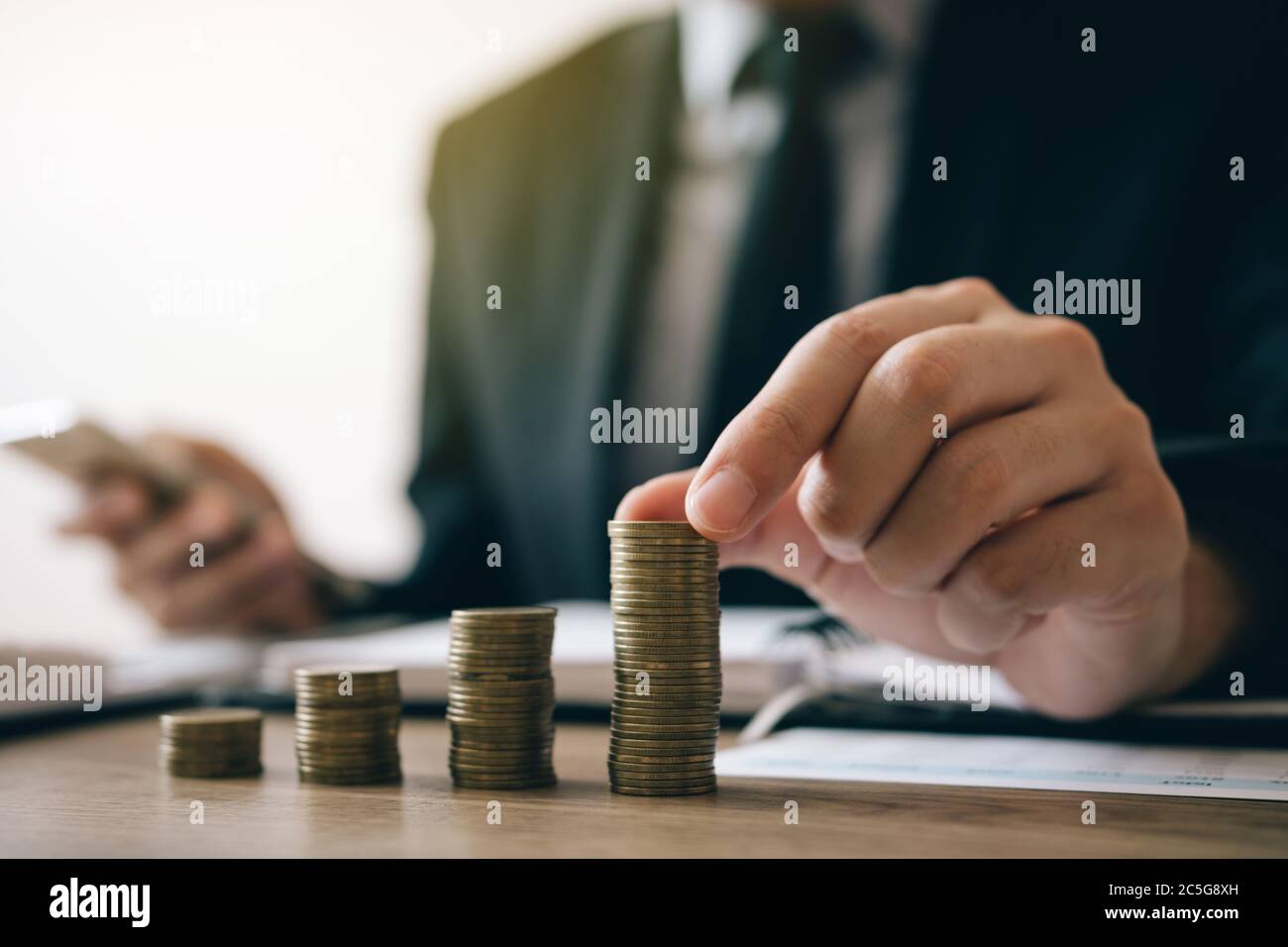 Asian investors man are placing coins in a growing position with ...