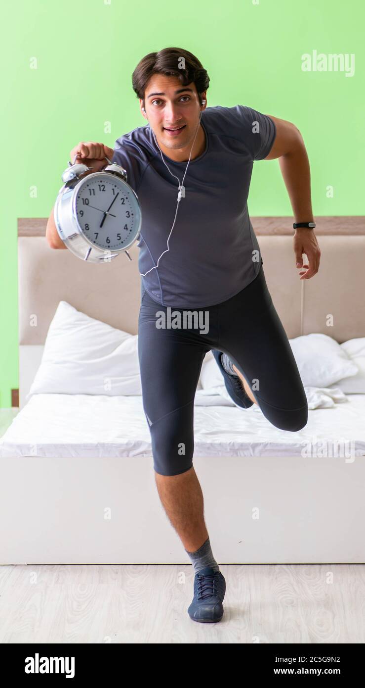 The young handsome man doing morning exercises in the hotel room Stock ...