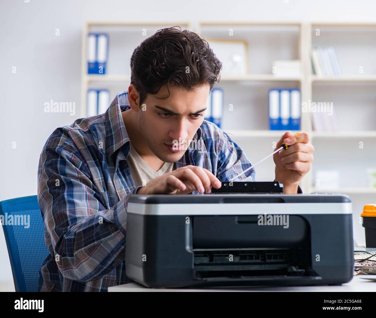 The hardware repairman repairing broken printer fax machine Stock Photo ...
