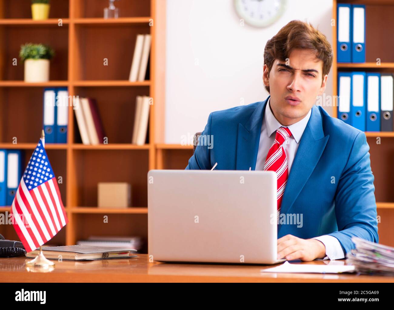 The young handsome politician sitting in office Stock Photo - Alamy
