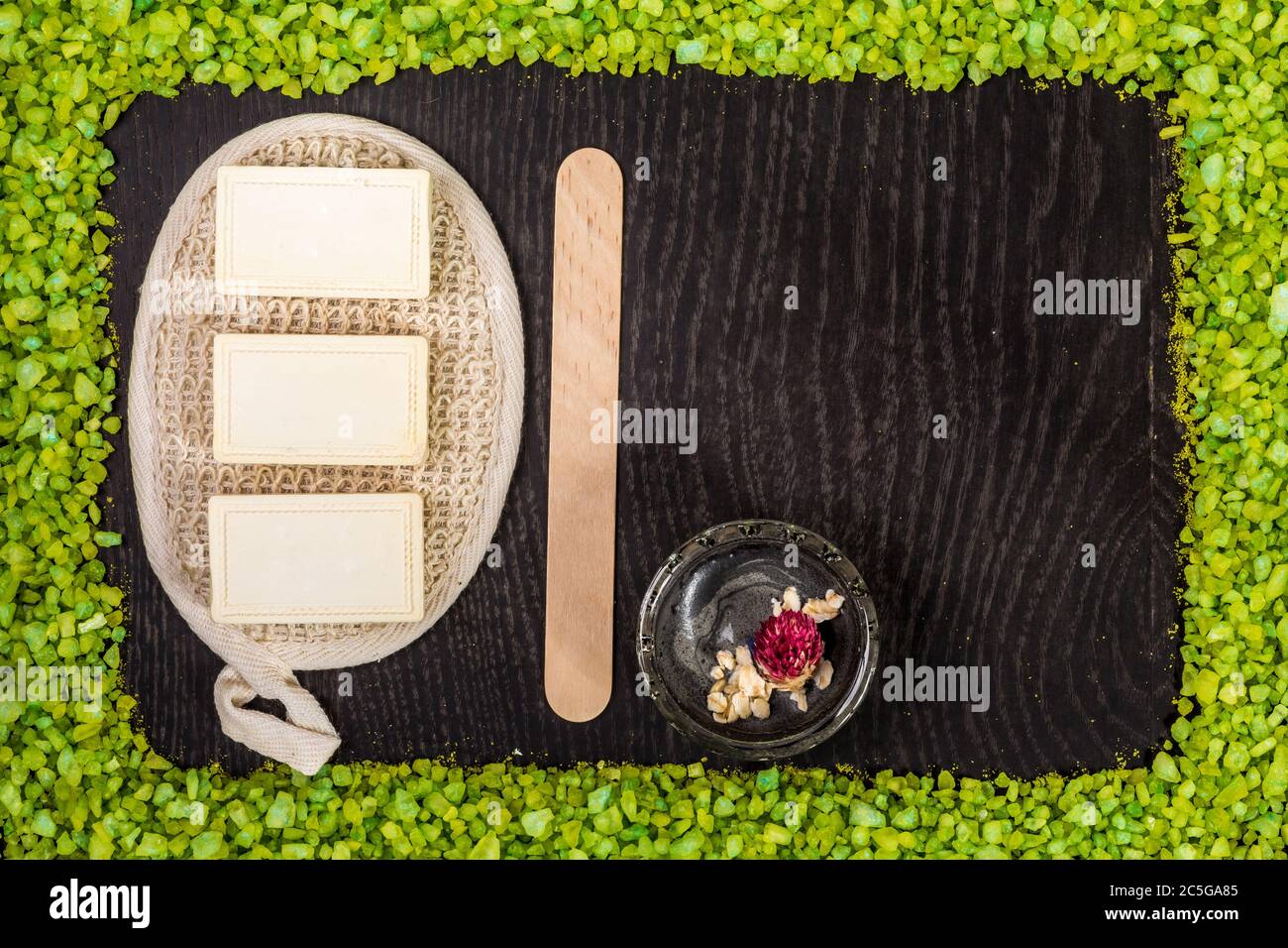 spa products: black mud and clay powder, soap, bath salt on wood table ...