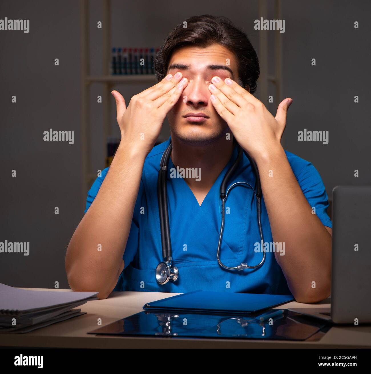The young handsome doctor working night shift in hospital Stock Photo ...
