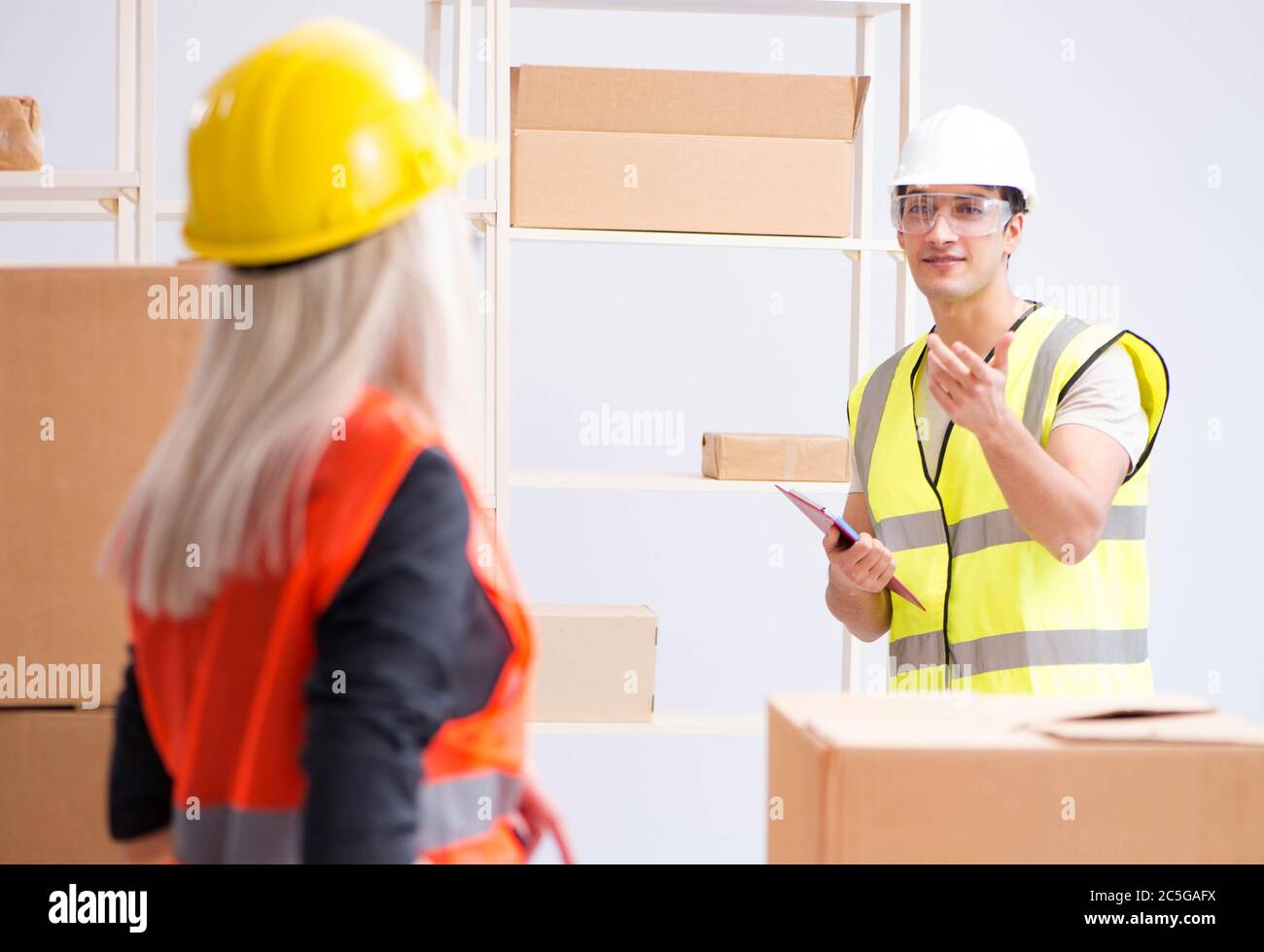 The delivery contractor delivering boxes to office Stock Photo - Alamy