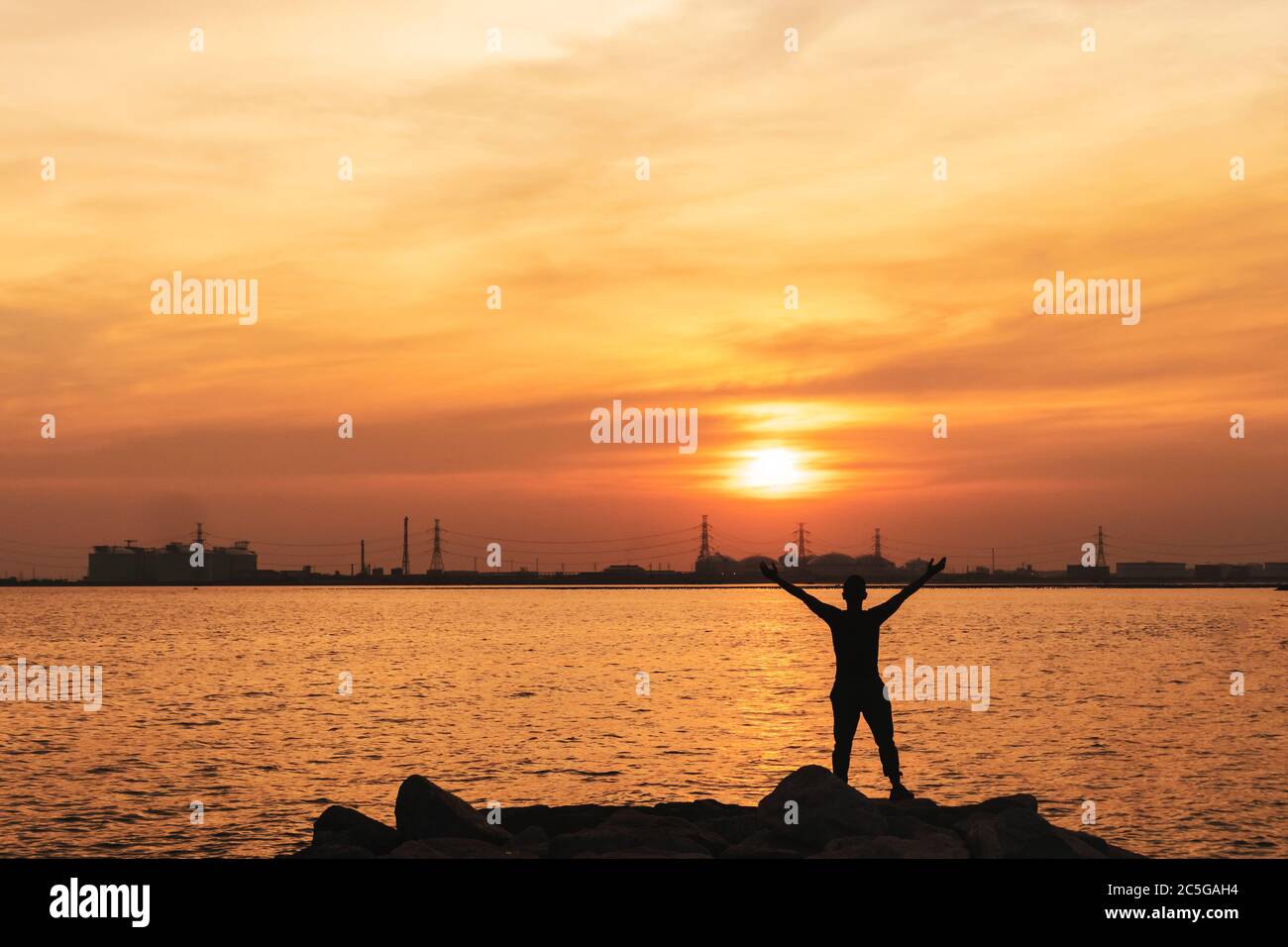 Man rise hands up to sky freedom concept with copyspace sunset sky ...