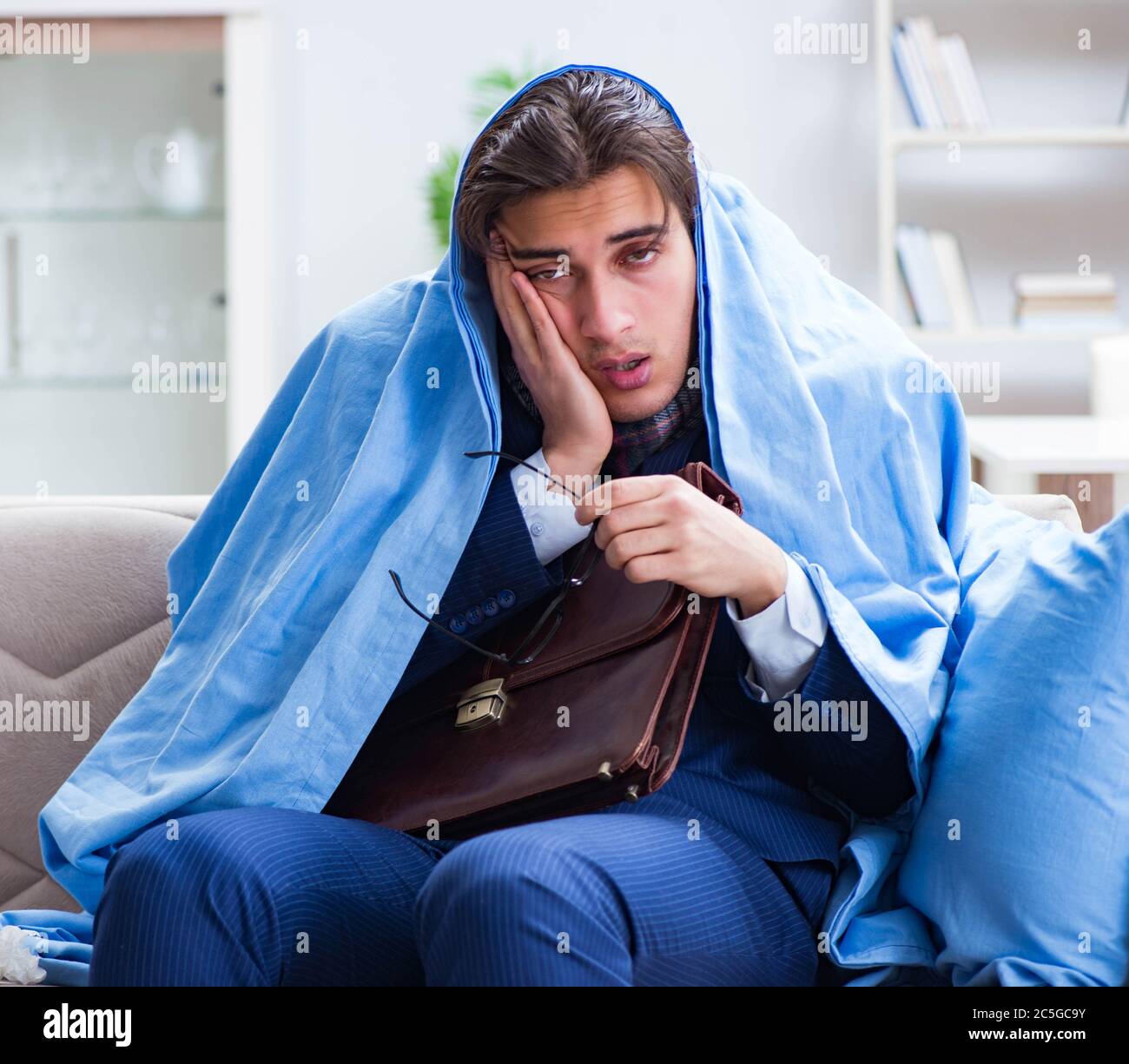 The sick employee staying at home suffering from flue Stock Photo - Alamy