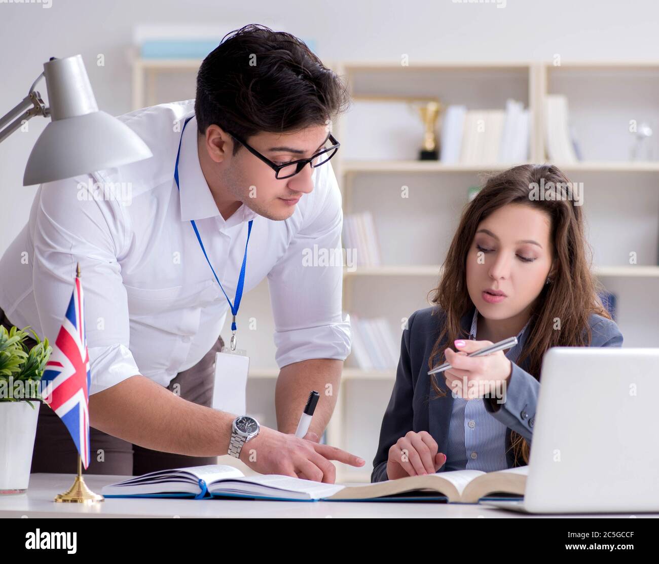 The teacher explaining to student at language training Stock Photo - Alamy