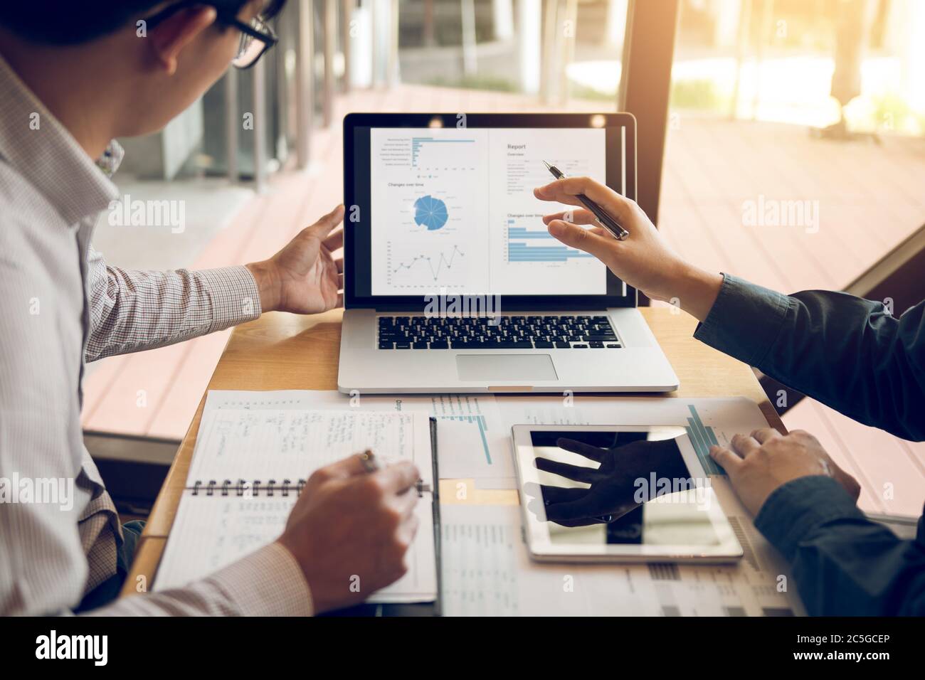 Businessman point to the graph of the company financial statements in ...