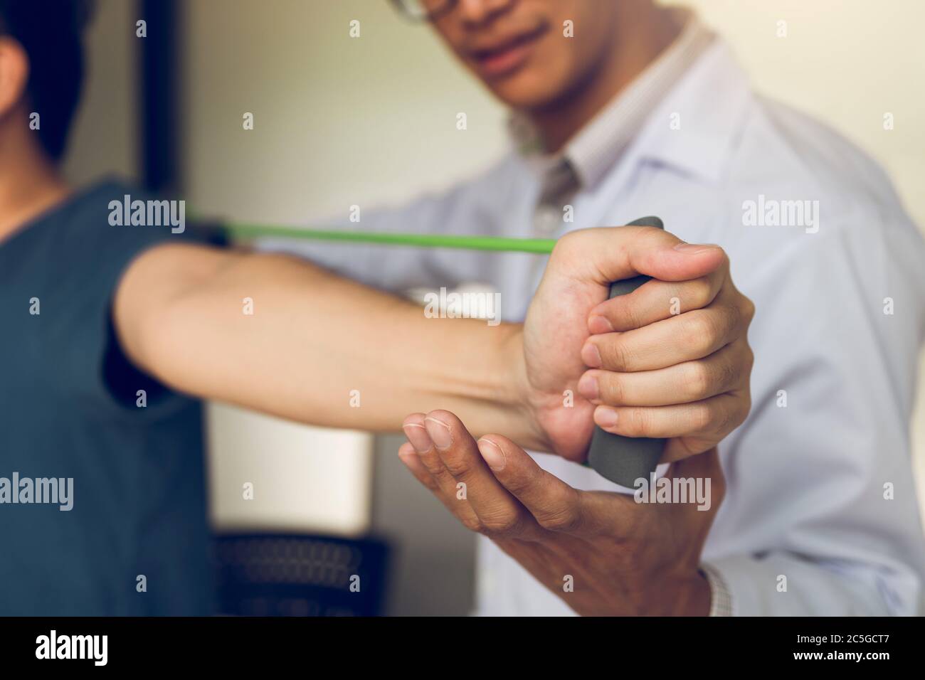 Asian male physical therapist descent working and helping to protect ...