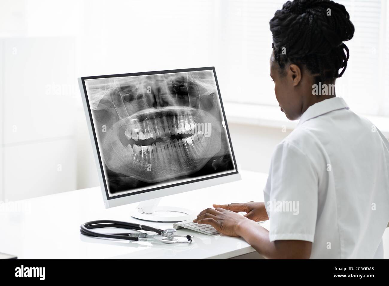 Dentist Doctor Looking At Teeth Xray Using Computer Software Stock ...