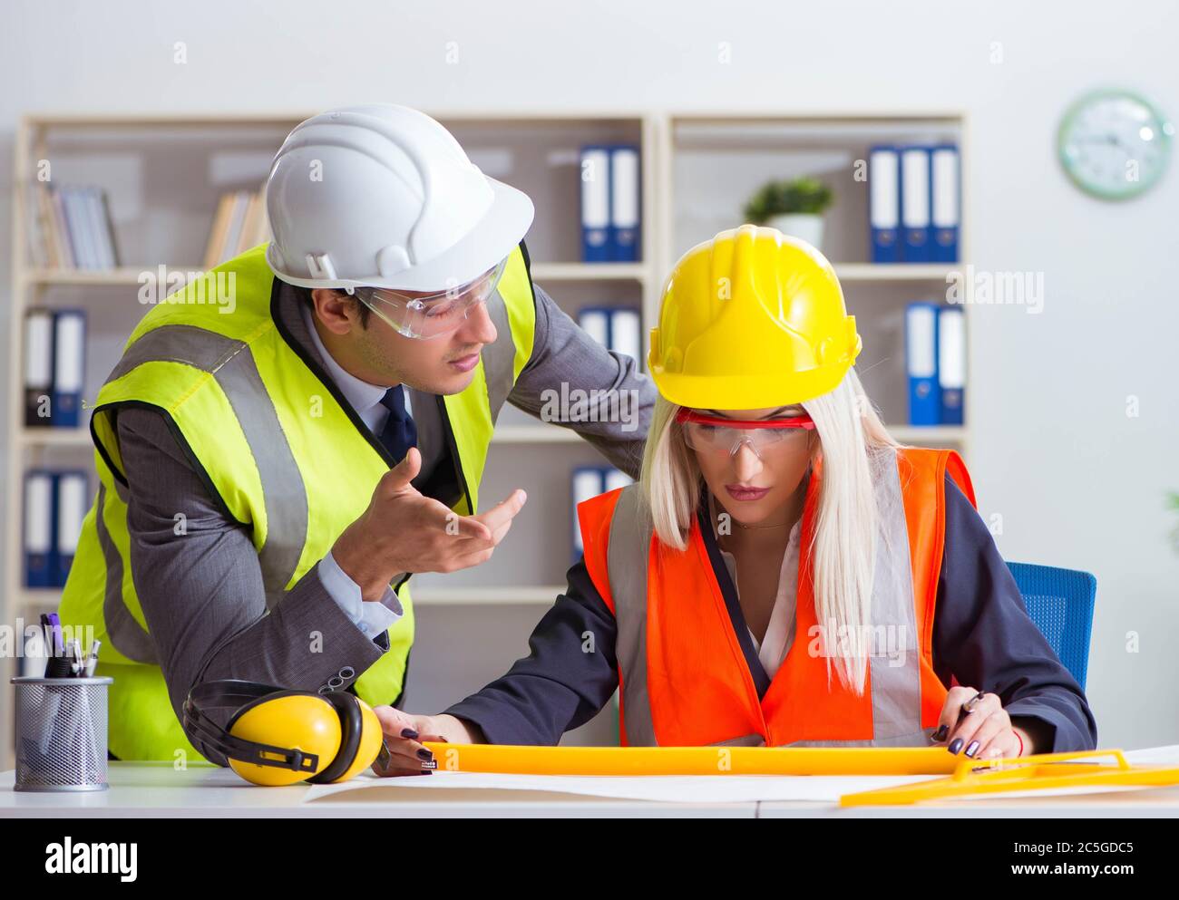 Construction workers having discussion in office before starting ...