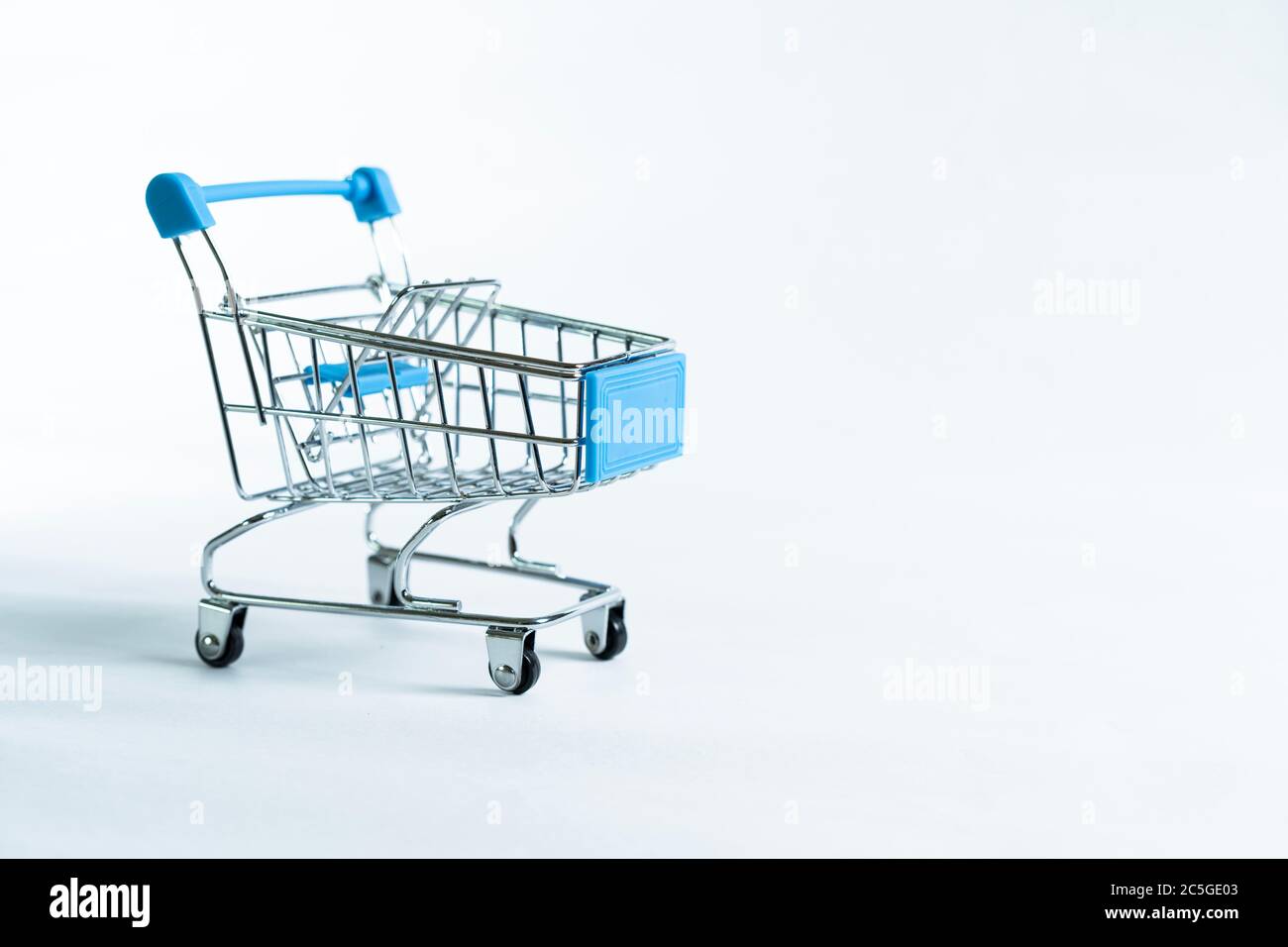 Mini shopping trolley isolated against white background Stock Photo - Alamy