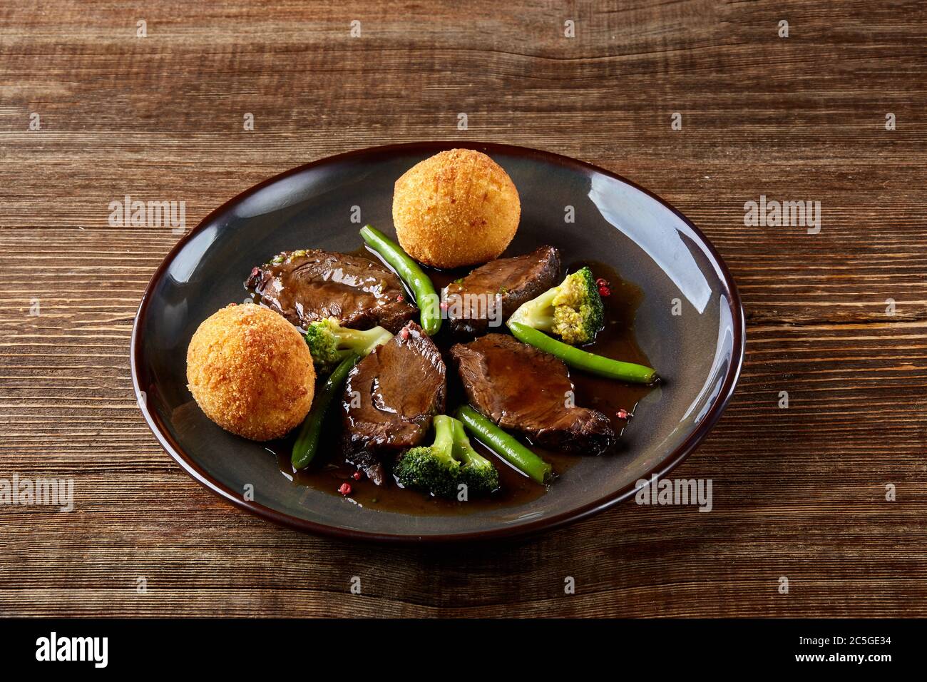 Stewed beef with vegetables on wooden background close up. Hot Meat ...