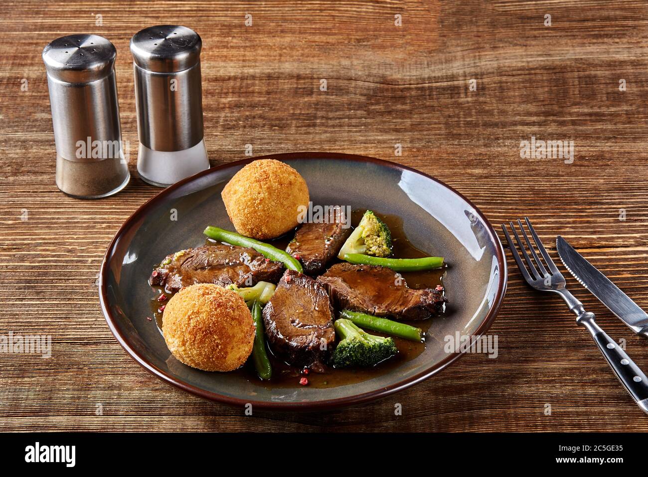 Stewed beef with vegetables on wooden background close up. Hot Meat ...