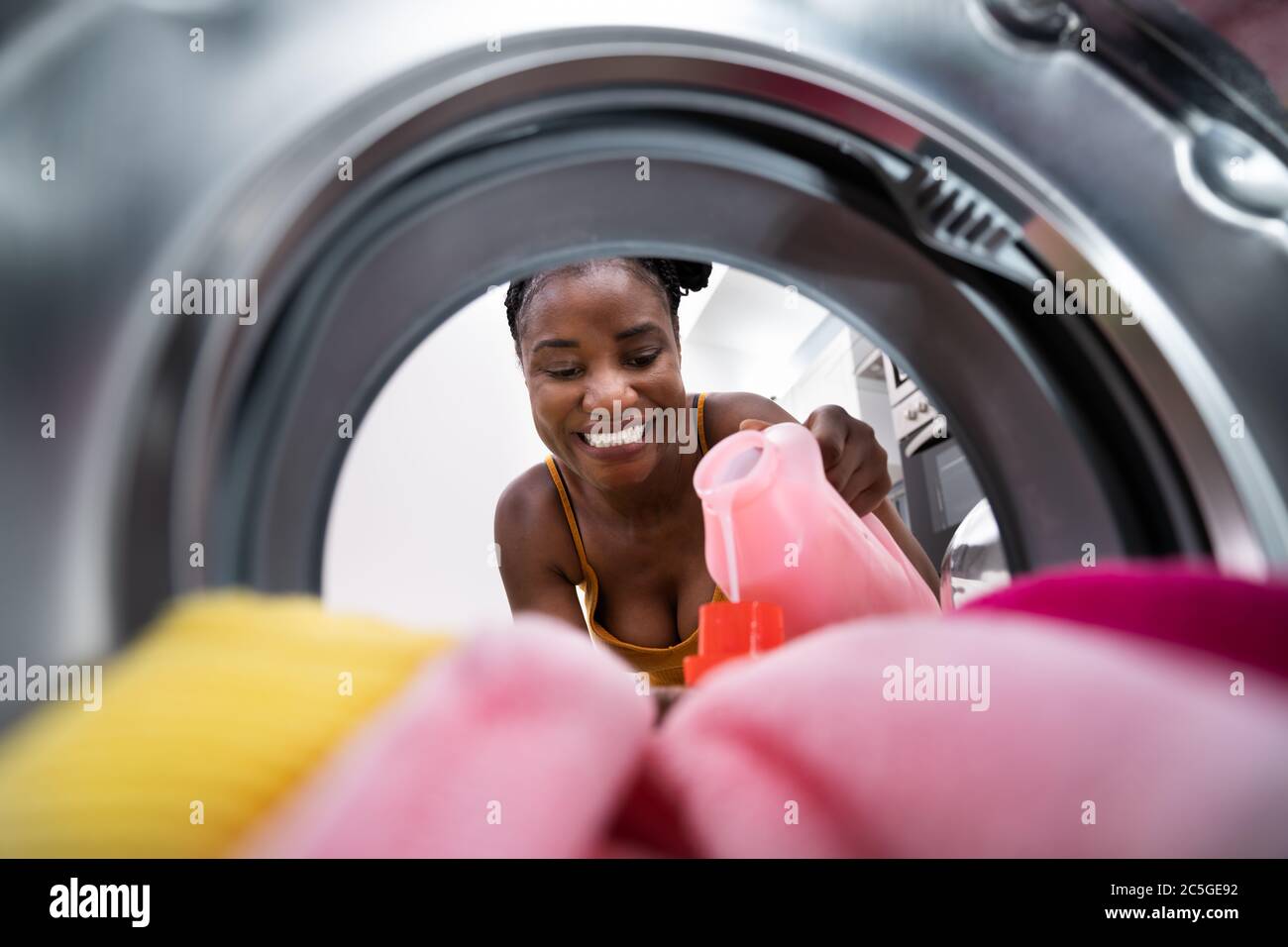 Woman using washing machine hi-res stock photography and images - Alamy