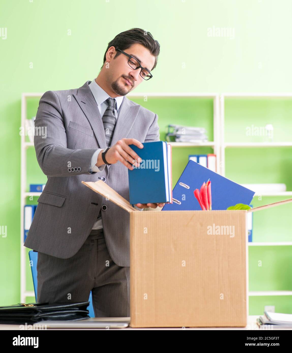 The male employee collecting his stuff after redundancy Stock Photo - Alamy