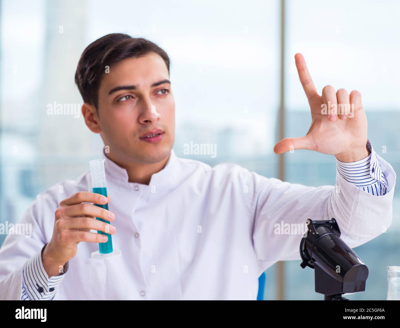 The young chemist pressing virtual buttons in lab Stock Photo - Alamy