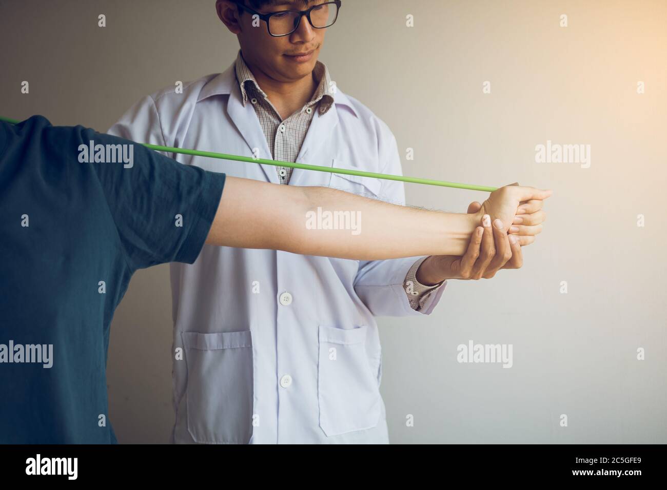 Asian male physical therapist descent working and helping to protect ...