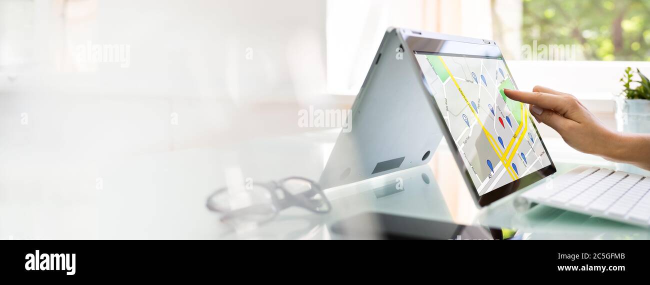 Searching Location On Online GPS Map Using Laptop Stock Photo - Alamy