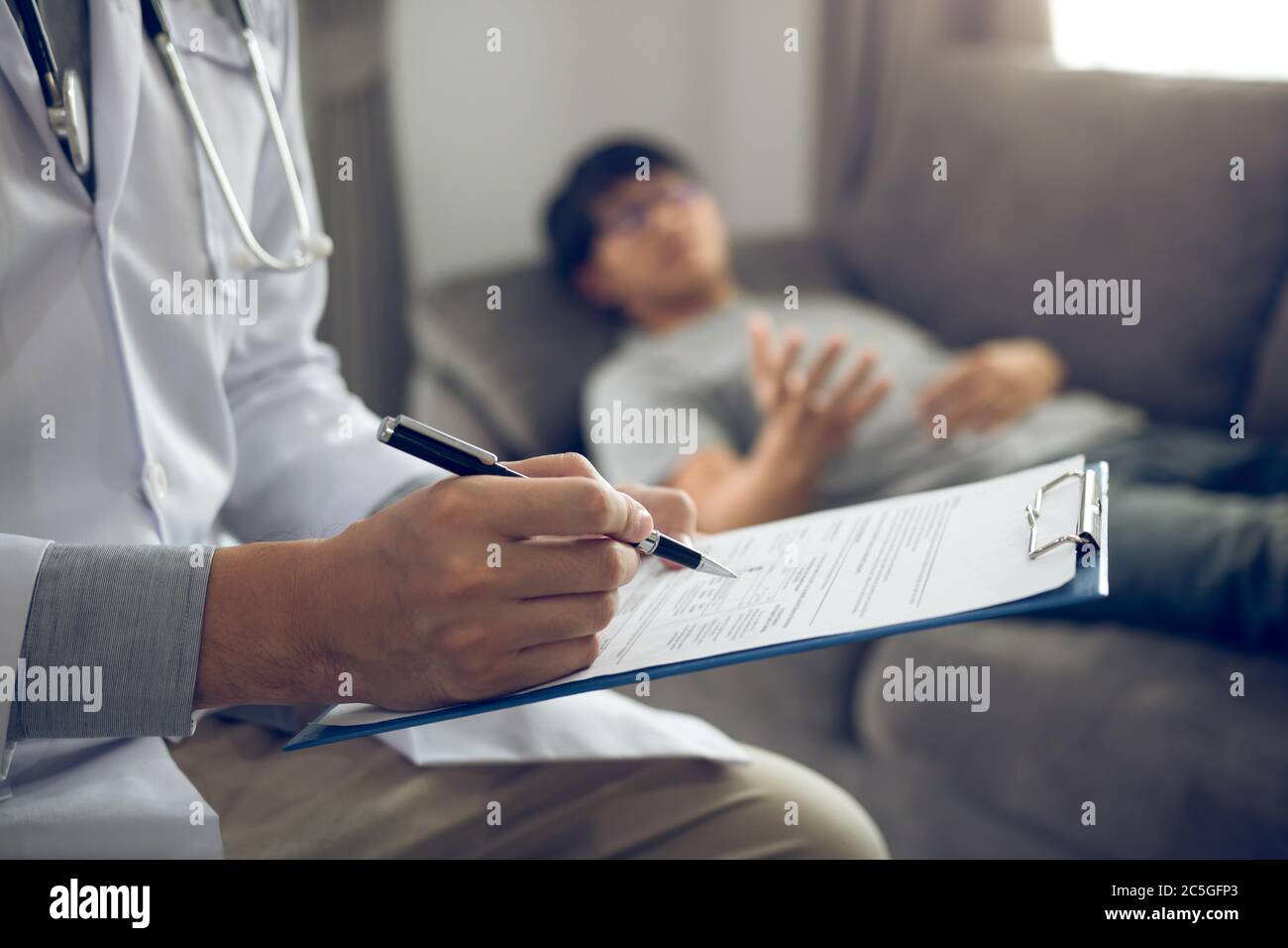 Close up of pen doctor writing with came to visit the patient at home ...