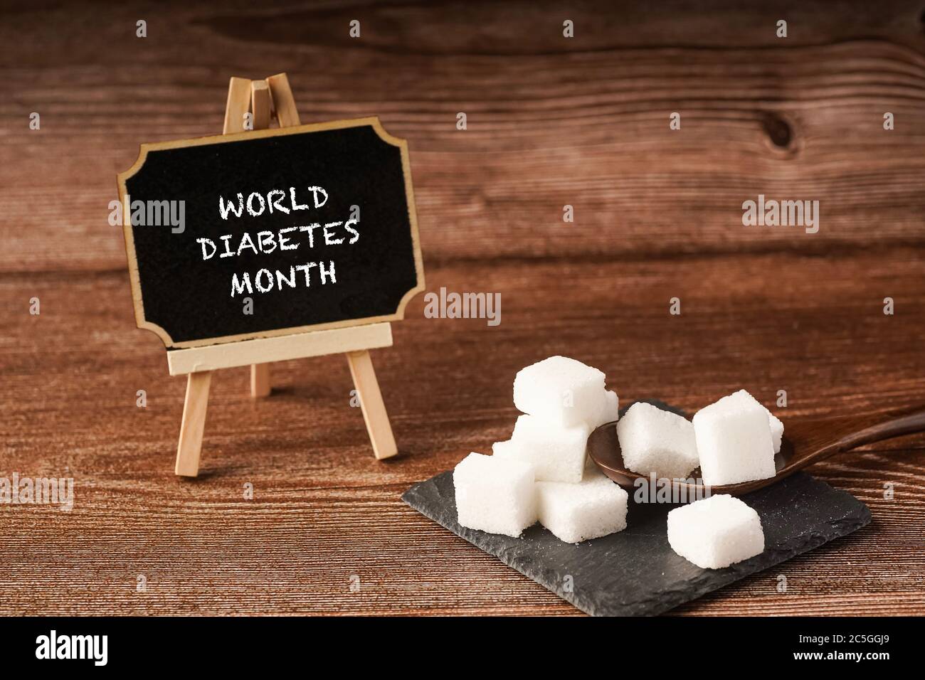 “World Diabetes Month” wordings on a chalkboard with sugar cubes ...