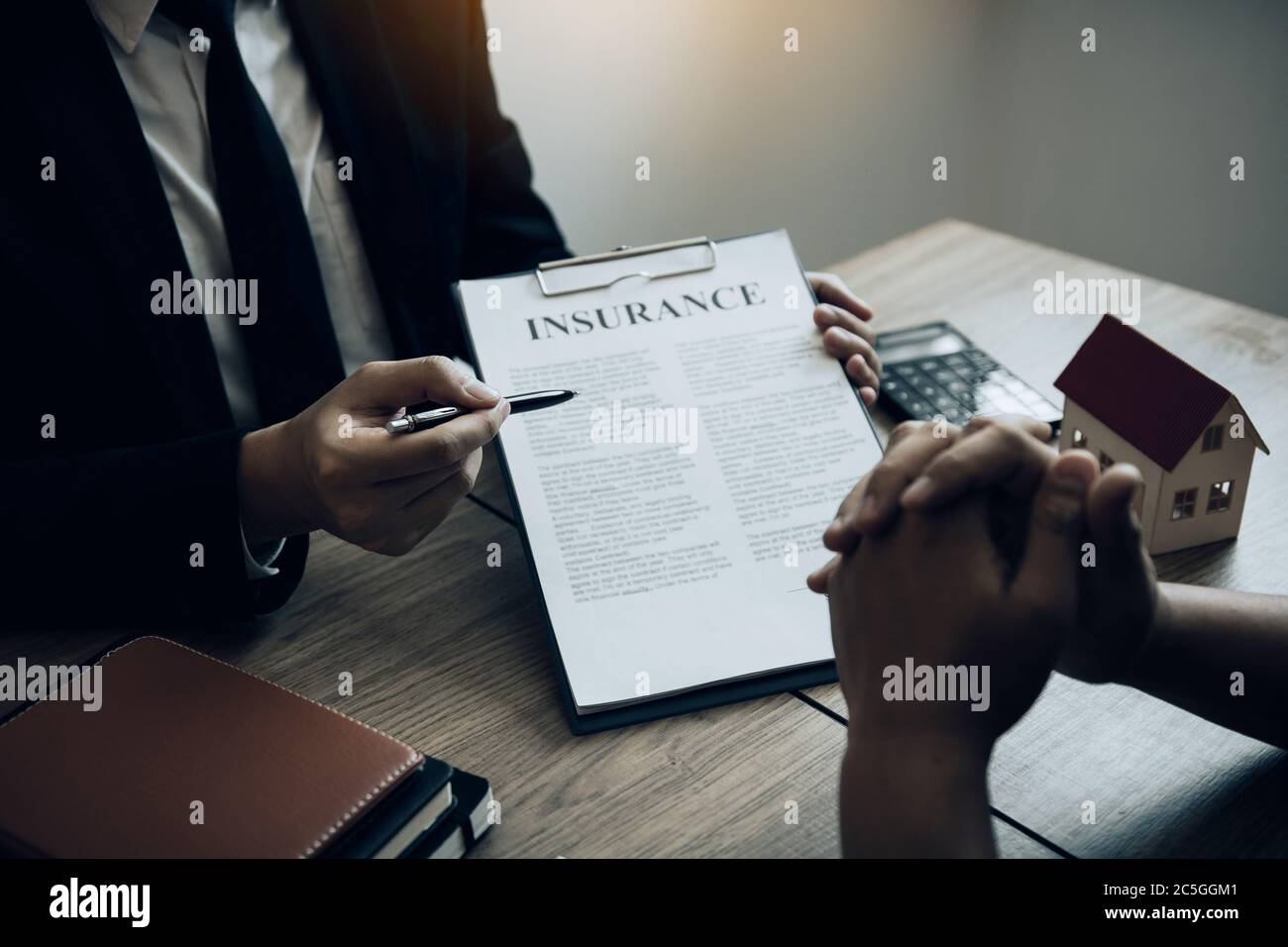 Agents are using pens pointing to insurance contracts and are being ...