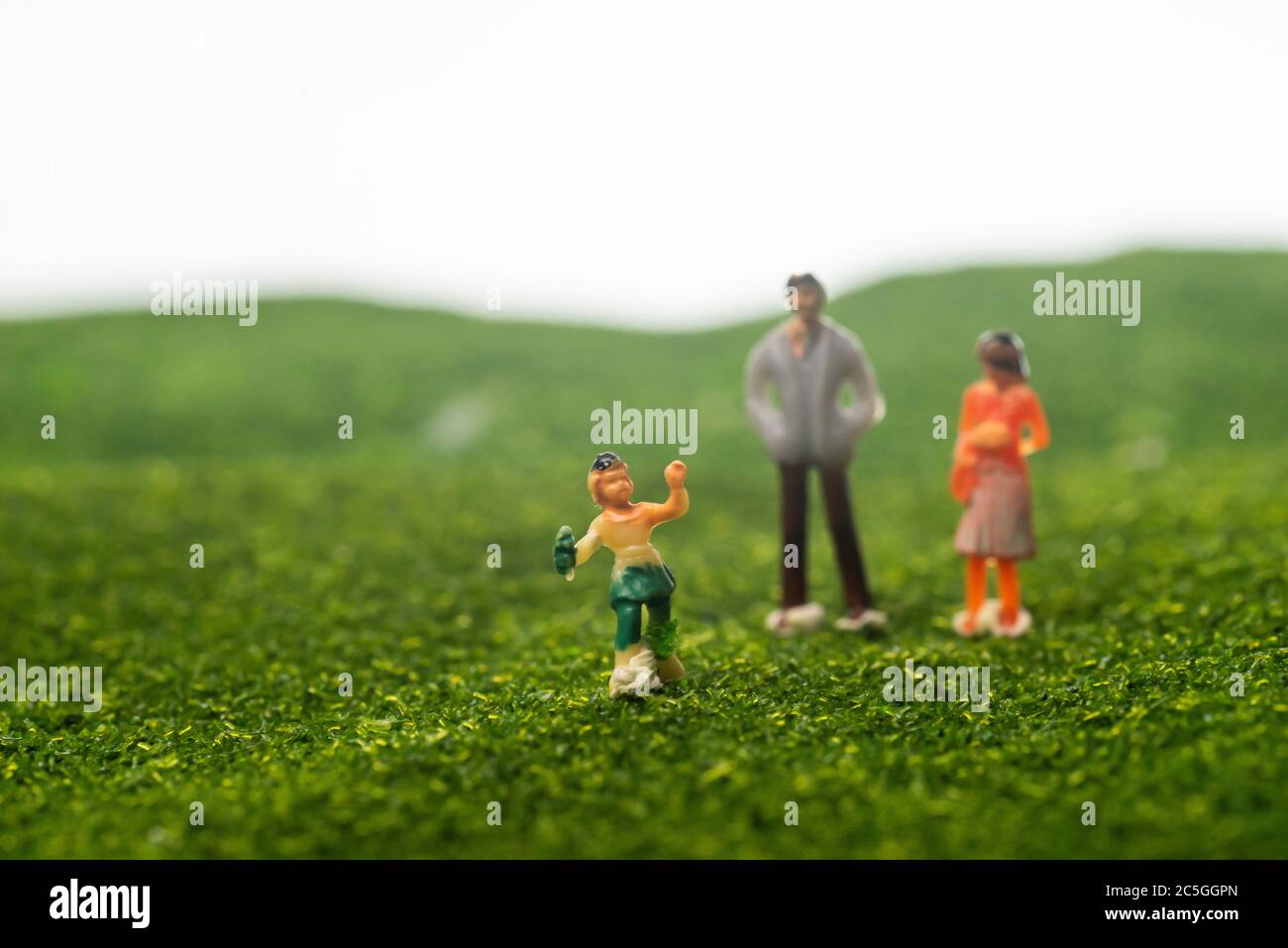 Happy family concept: Miniature family figurines on a park. Selective ...