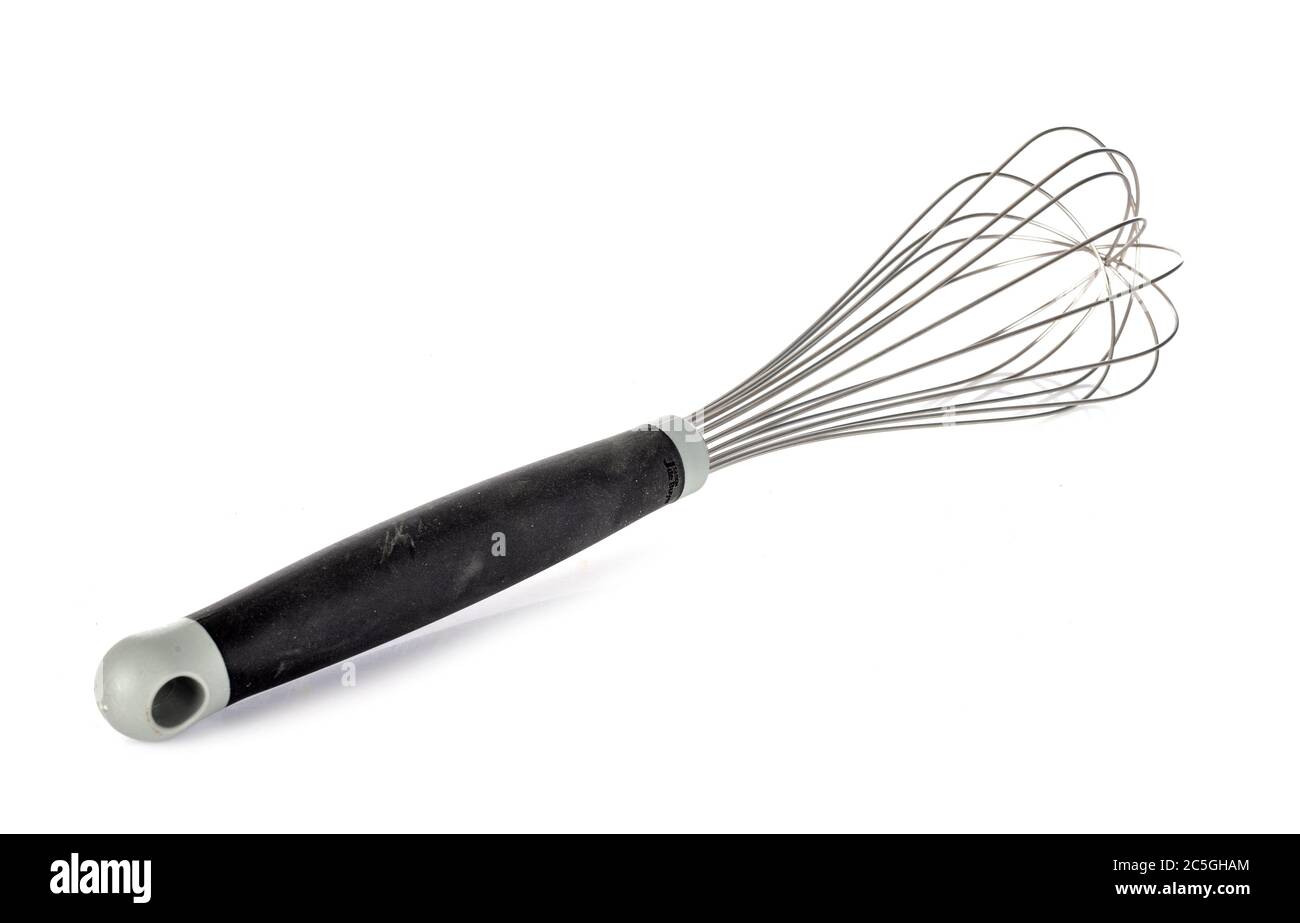 steel whisk in front of white background Stock Photo - Alamy