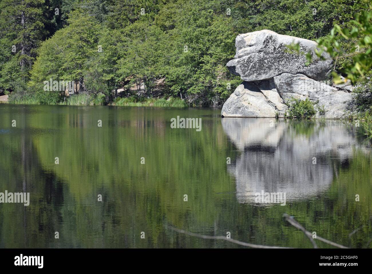Boulder in a Lake Stock Photo - Alamy