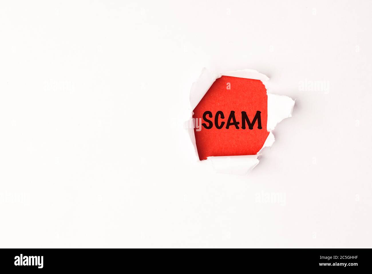 SCAM wording on a torn paper background Stock Photo - Alamy