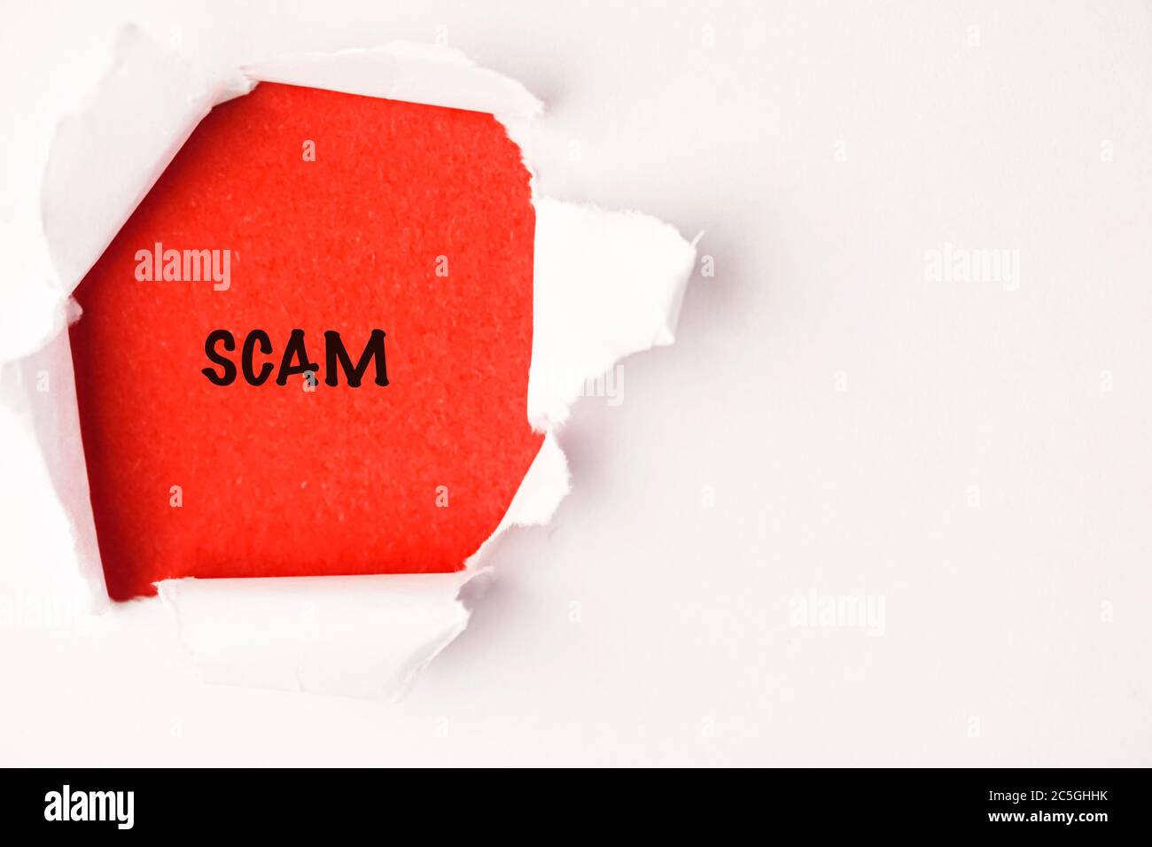 SCAM wording on a torn paper background Stock Photo - Alamy