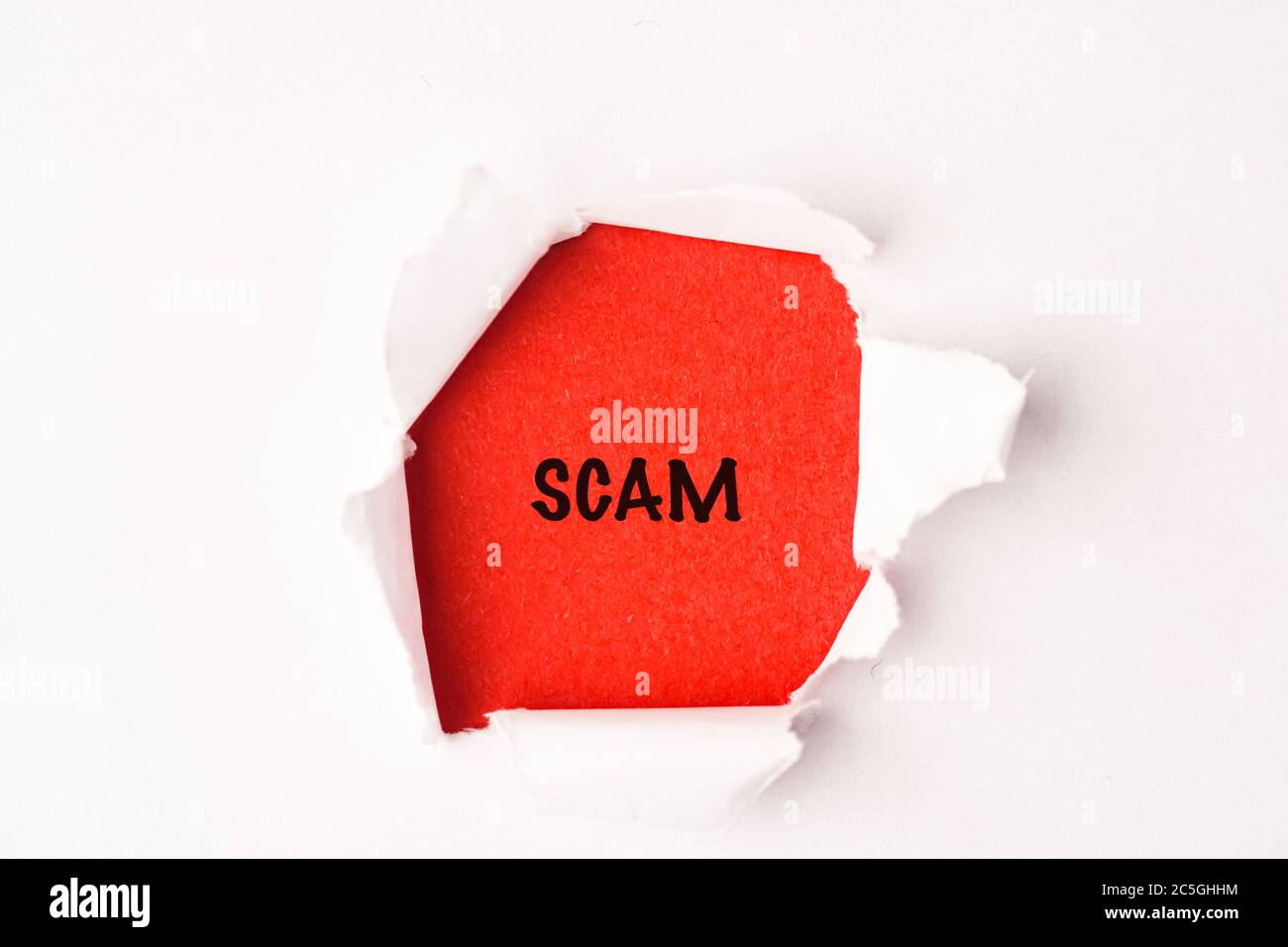 SCAM wording on a torn paper background Stock Photo - Alamy