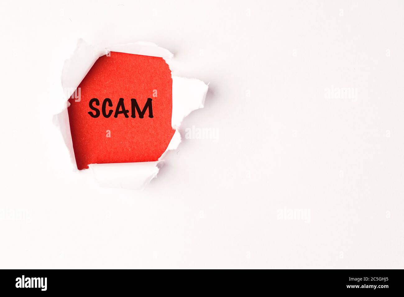 SCAM wording on a torn paper background Stock Photo - Alamy