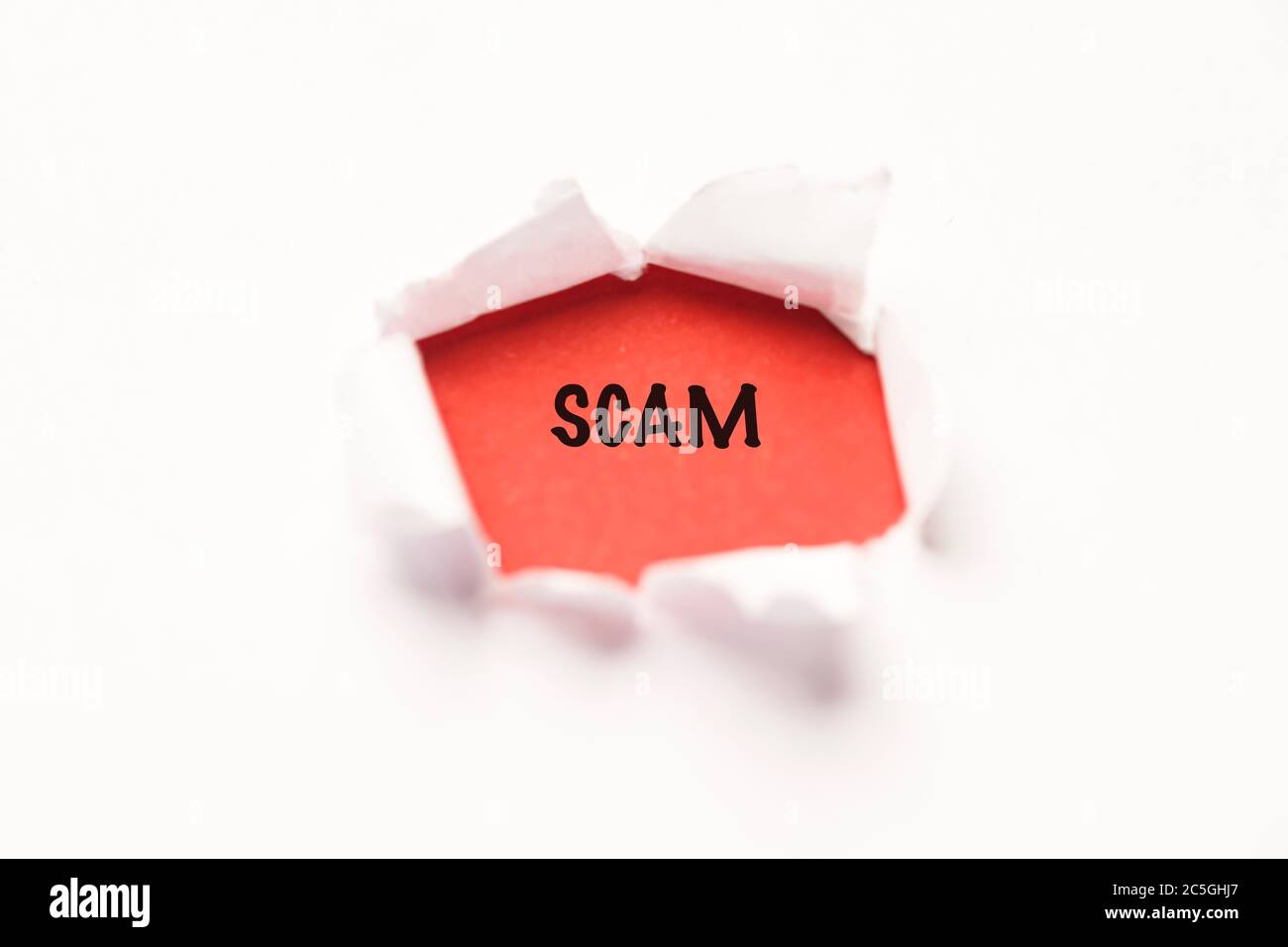 SCAM wording on a torn paper background Stock Photo - Alamy