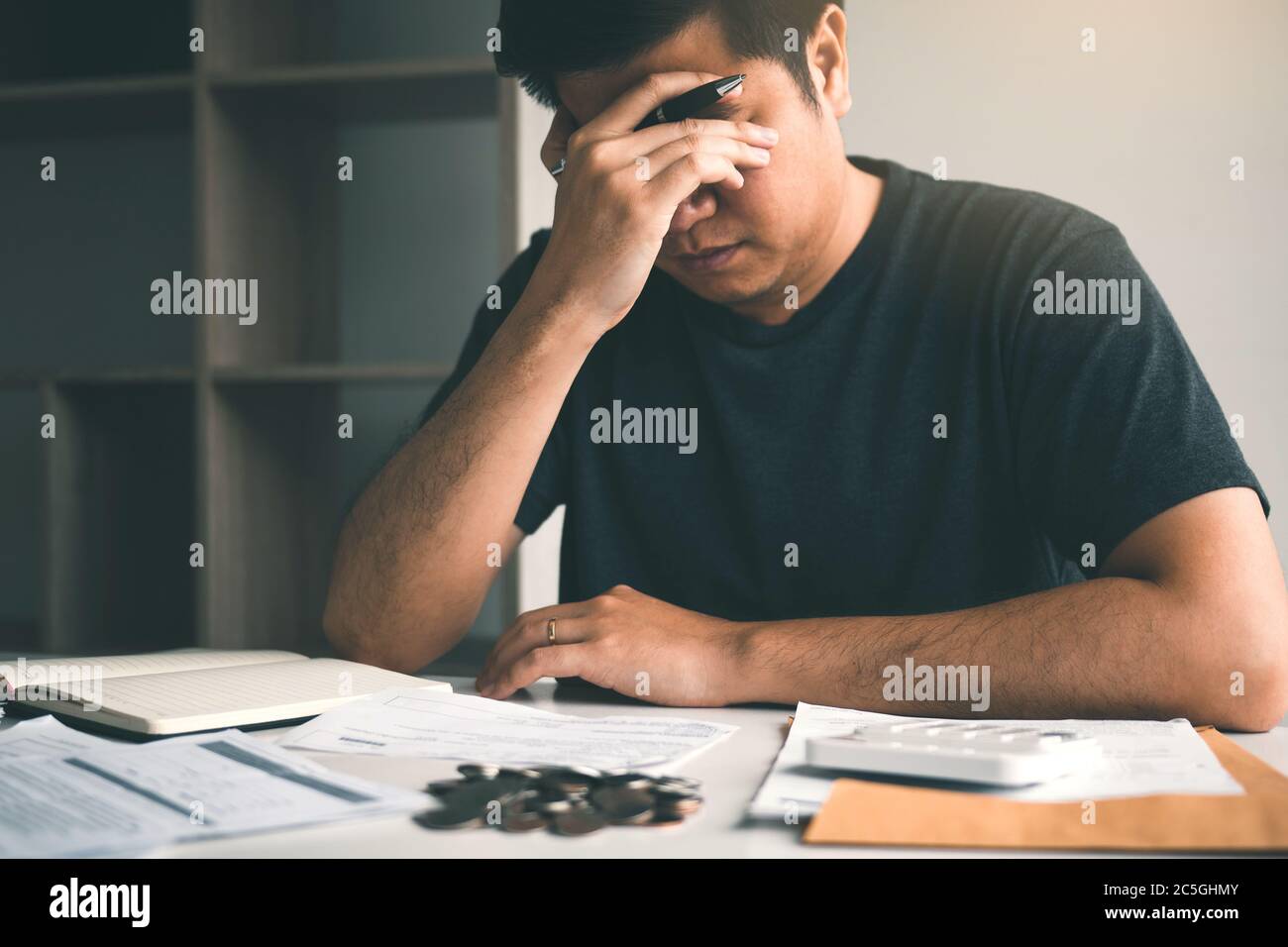 Asian men are stressed about financial problems, with invoices and ...