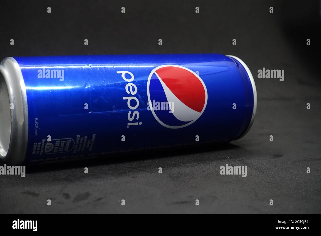 A can of blue pepsi against isolated black background Stock Photo - Alamy