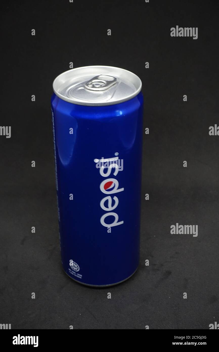 A can of blue pepsi against isolated black background Stock Photo - Alamy