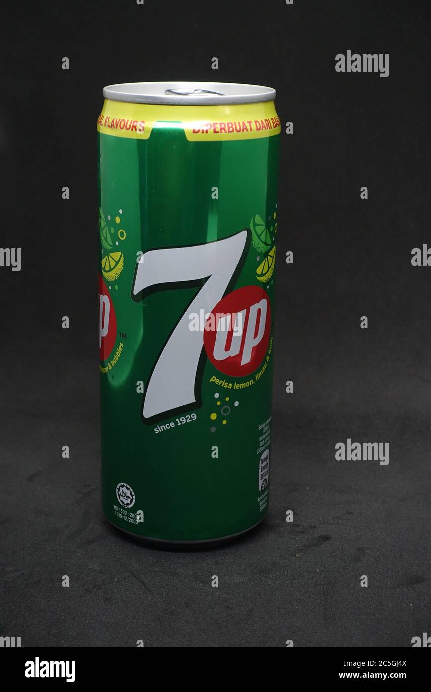 A 7up can against isolated black background, a tasty fruits flavour ...