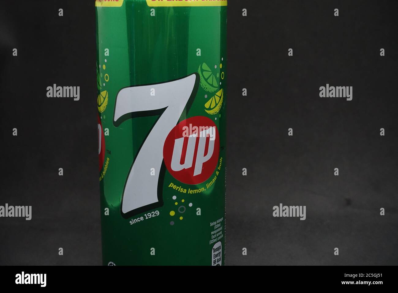 A 7up can against isolated black background, a tasty fruits flavour ...