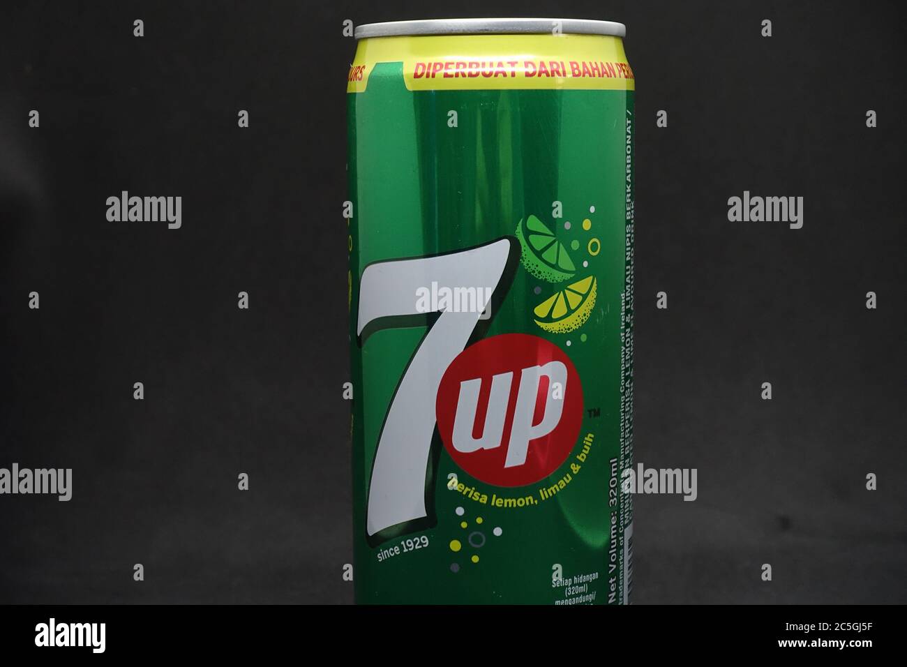 A 7up can against isolated black background, a tasty fruits flavour ...