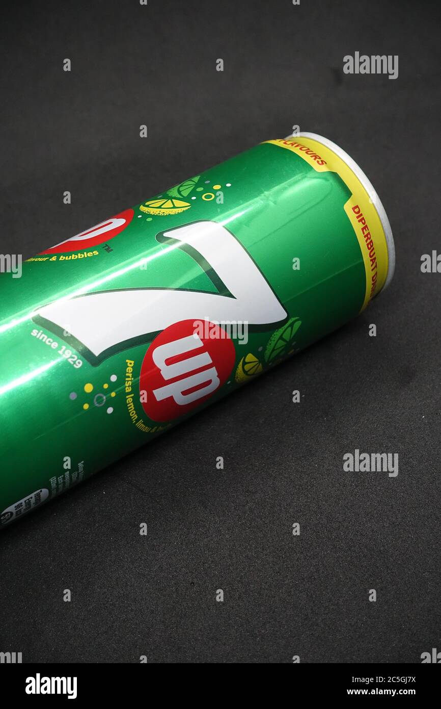 A 7up can against isolated black background, a tasty fruits flavour ...