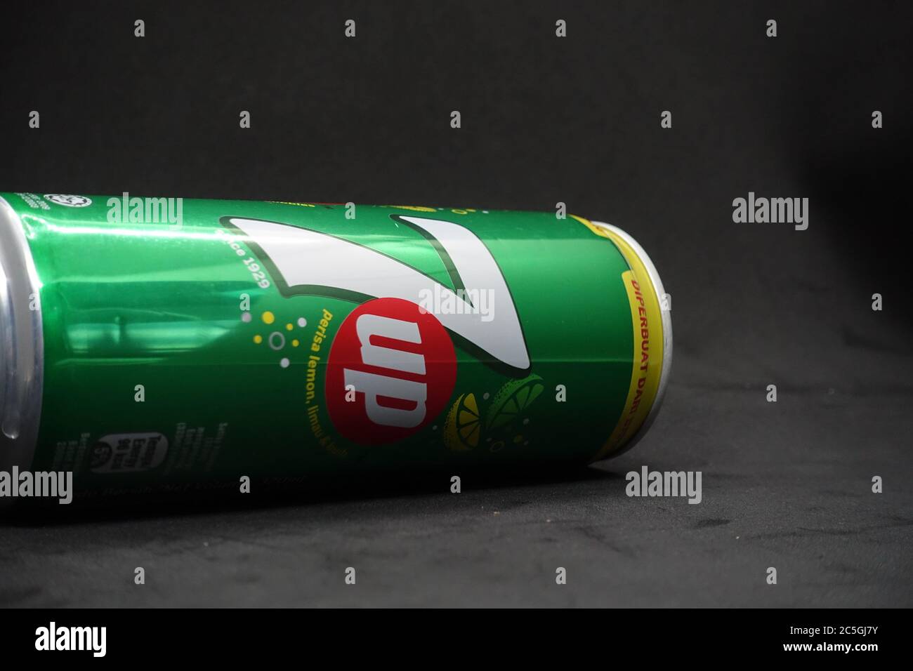 A 7up can against isolated black background, a tasty fruits flavour ...