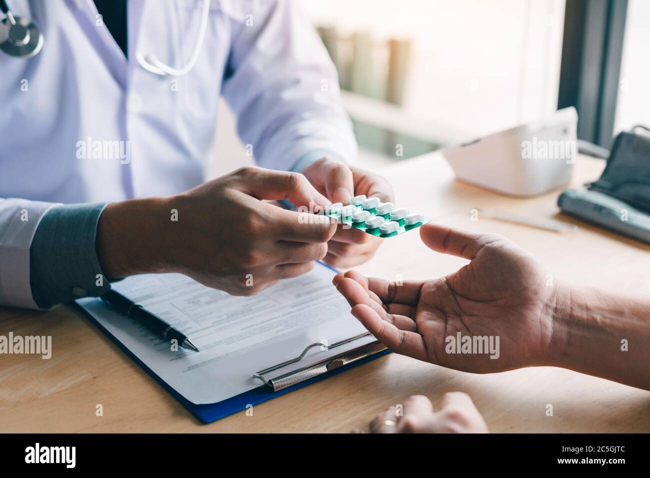 Doctor is pointing to drug tablet and introducing the properties of the ...
