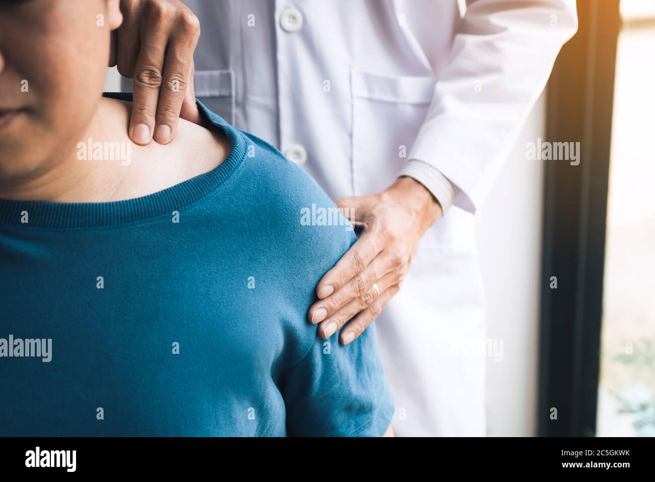 Physical therapists are using their hands to press the clavicle of the ...