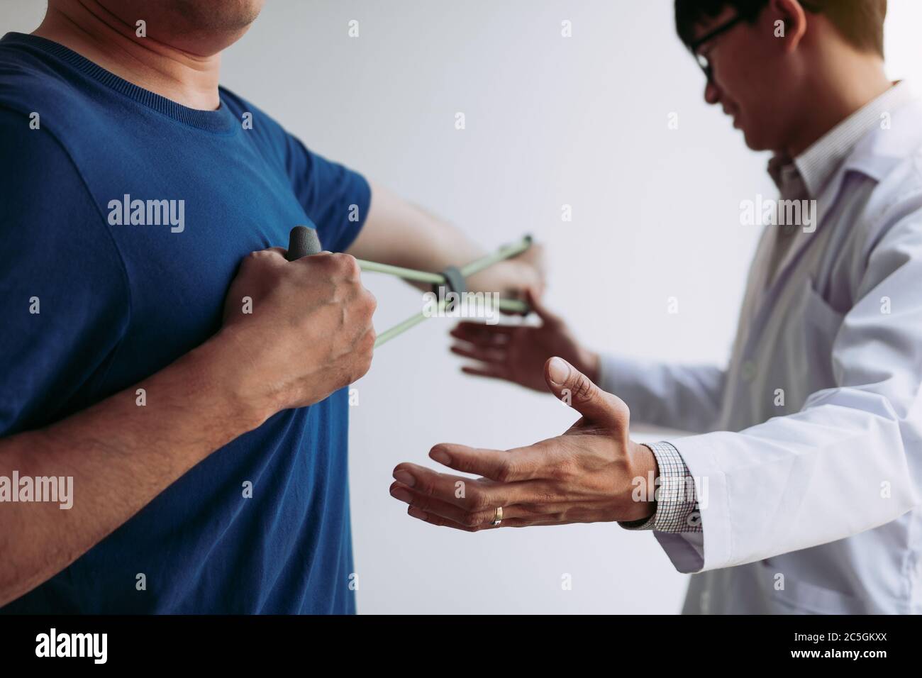 Asian male physical therapist descent working and helping to protect ...