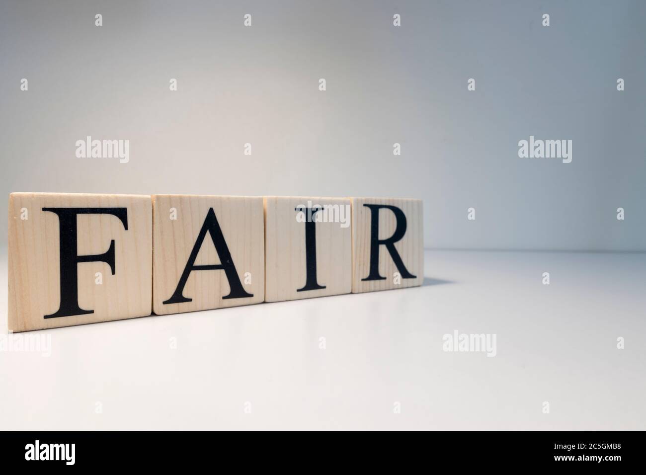 Fair word from wooden cubes. About law terms Stock Photo - Alamy
